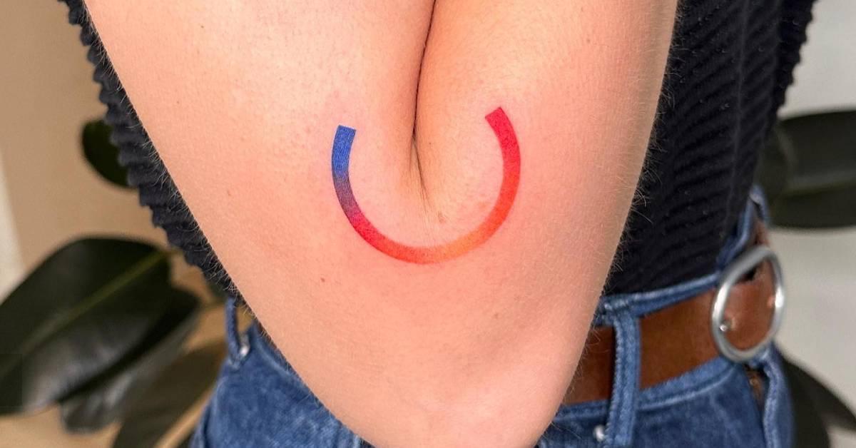 Spectrum tattoo located on the elbow, watercolor style.