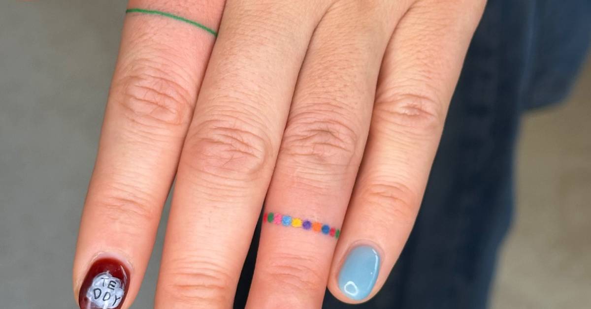 Hand poked green and colorful rings tattooed on the