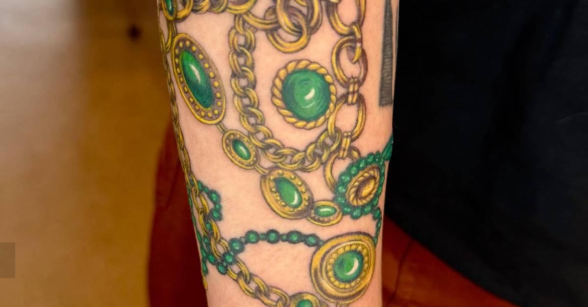 Illustrative style jewellery tattoo located on the