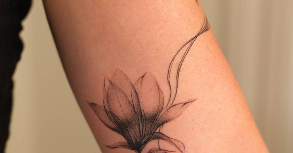 X-ray magnolia tattoo located on the inner arm.