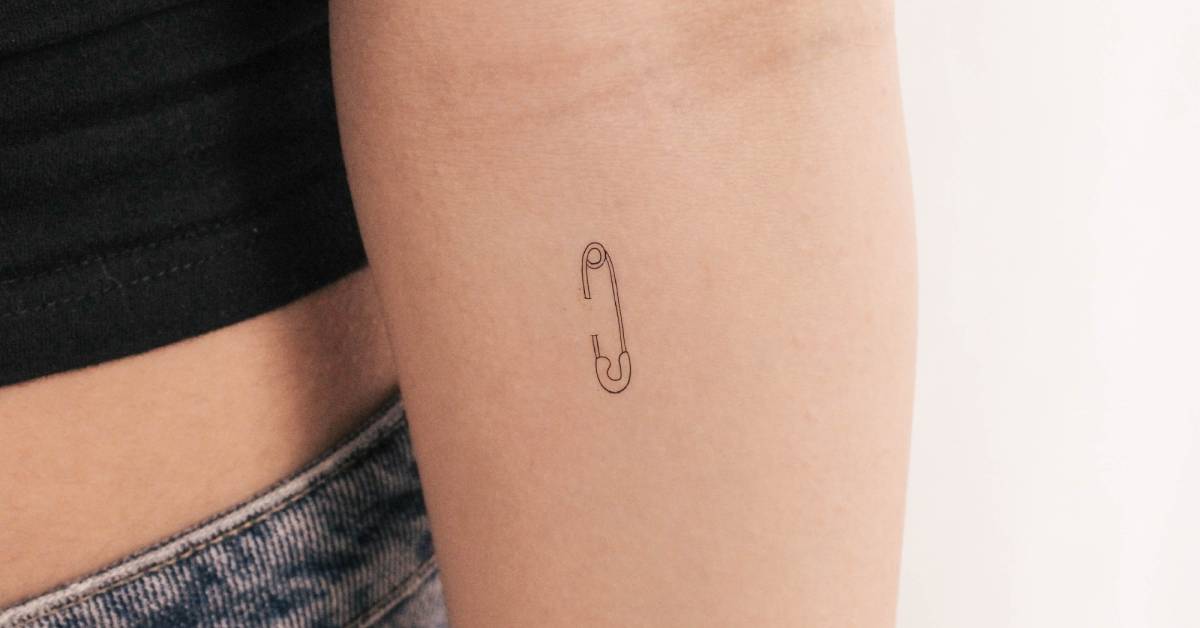 Safety pin temporary tattoo in fine line style.