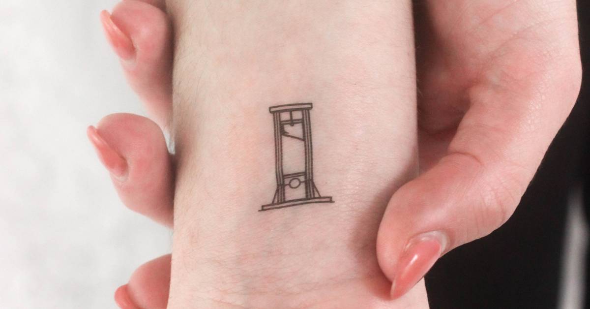 Guillotine temporary tattoo located on the wrist.