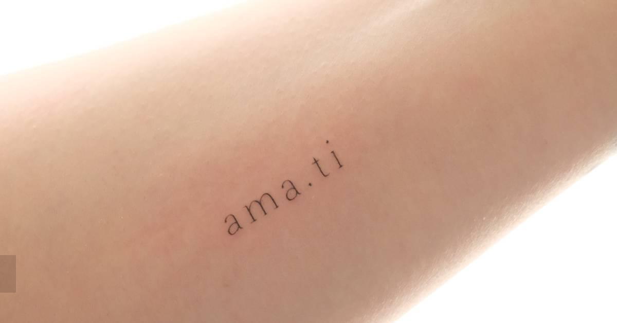 "Ama.ti" lettering tattoo in serif font placed on the