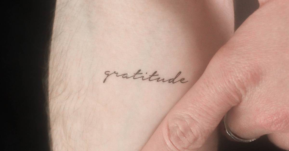 Word "gratitude" temporary lettering tattoo located on
