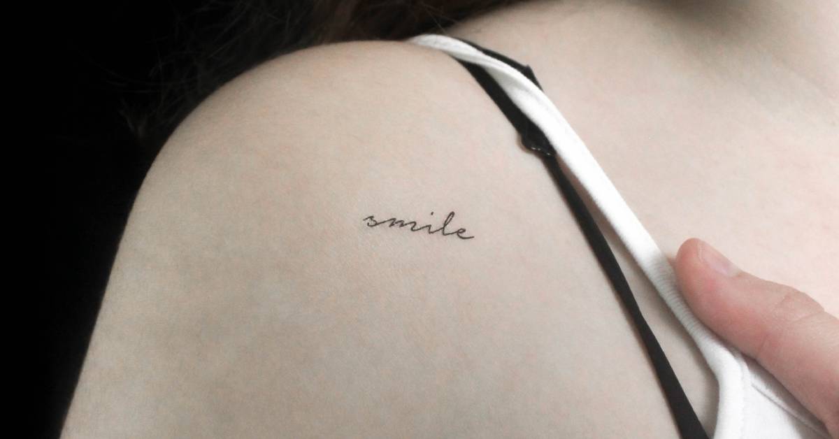 Handwritten word 'smile' temporary lettering tattoo