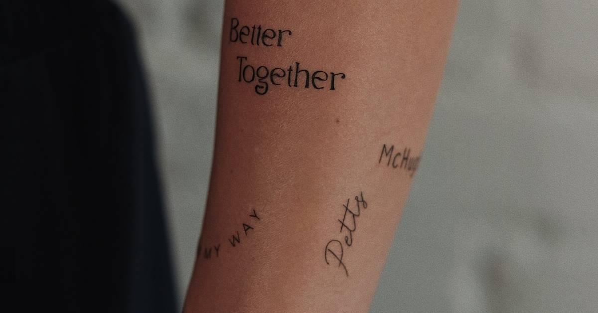 Lettering forearm composition tattoos.
