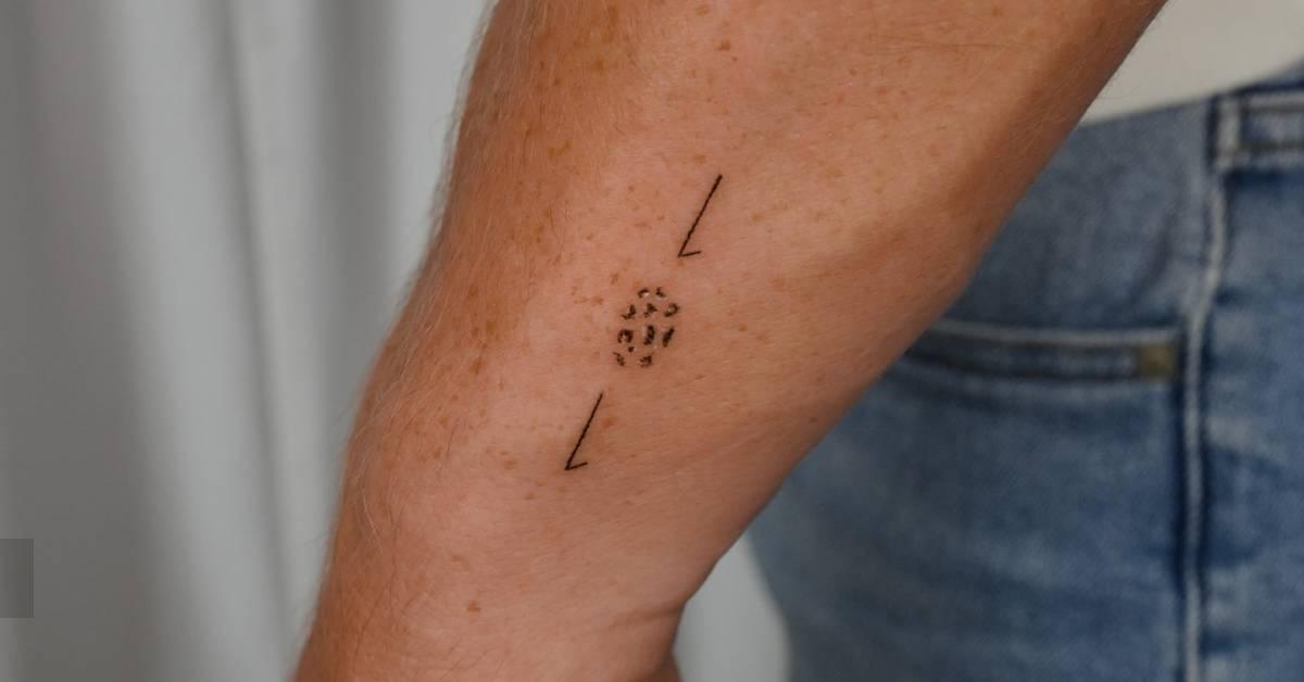 Number "101" tattoo placed on the wrist.