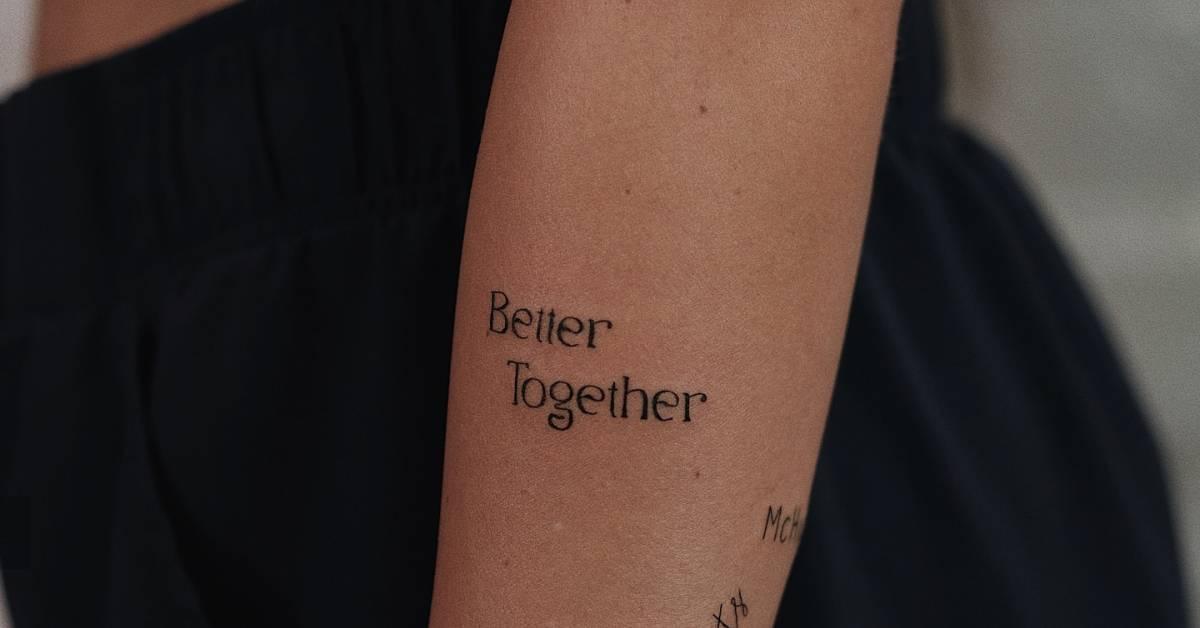 Lettering arm composition tattoos.