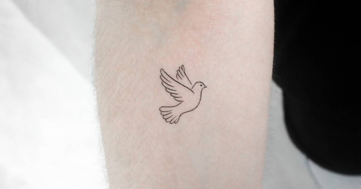 Fine line style dove temporary tattoo located on the