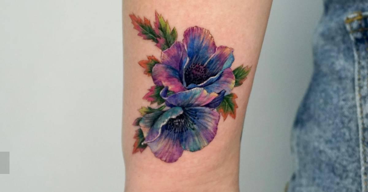 Blue poppy tattoo in realistic style located on the