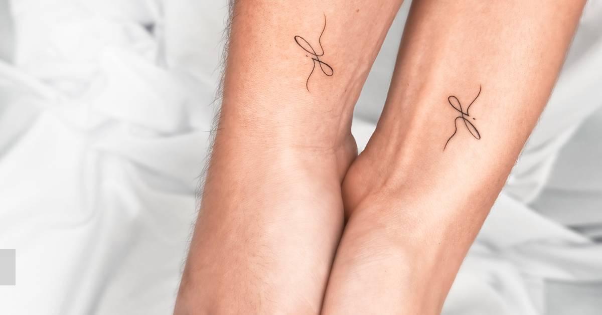 Matching handwritten initials tattoo for couple.