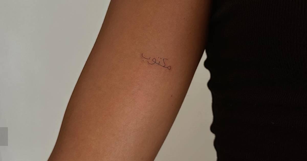 Arabic lettering tattoo located on the inner arm.