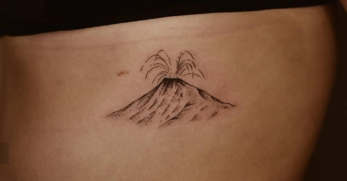 Illustrative style volcano tattoo located on the rib.