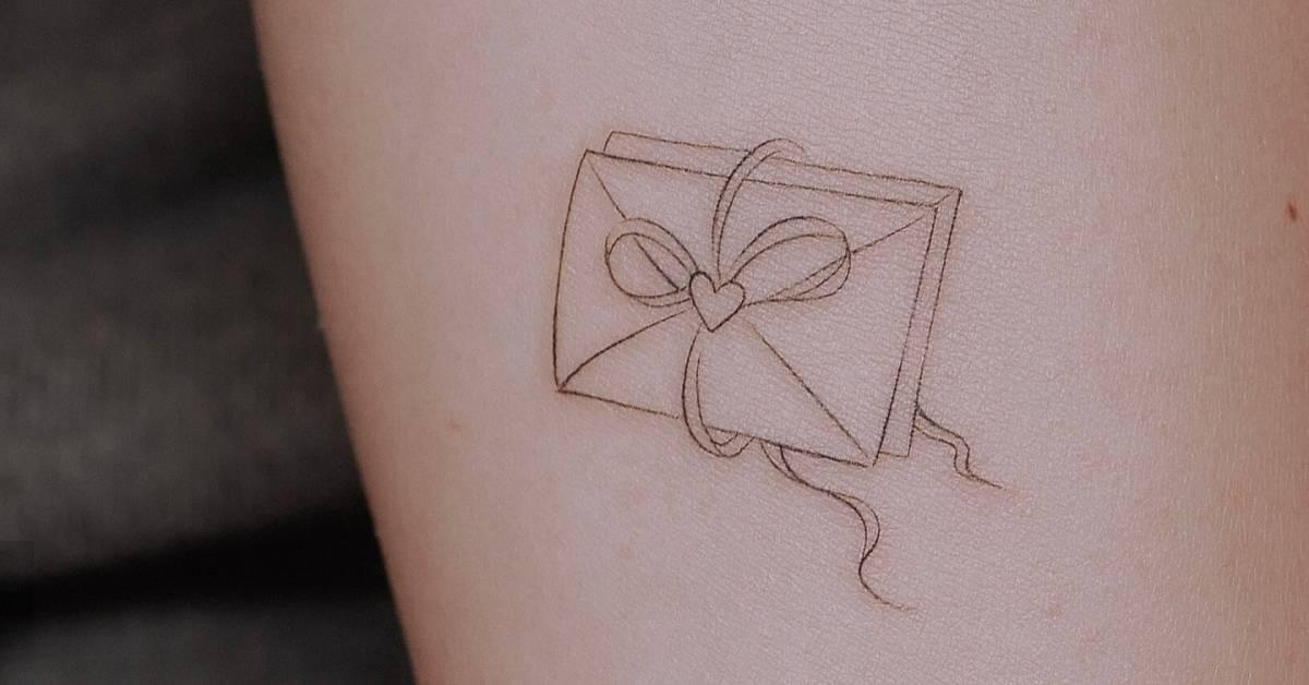Love letter tattoo in fine line style located on the