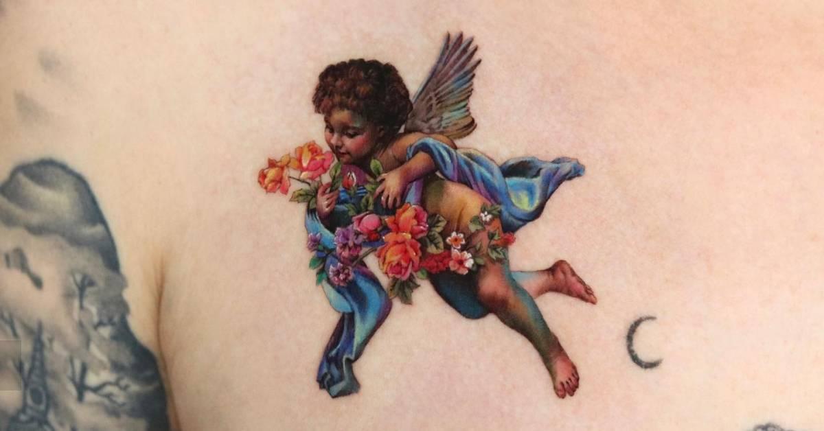 Realistic style cherub tattoo located on the chest.