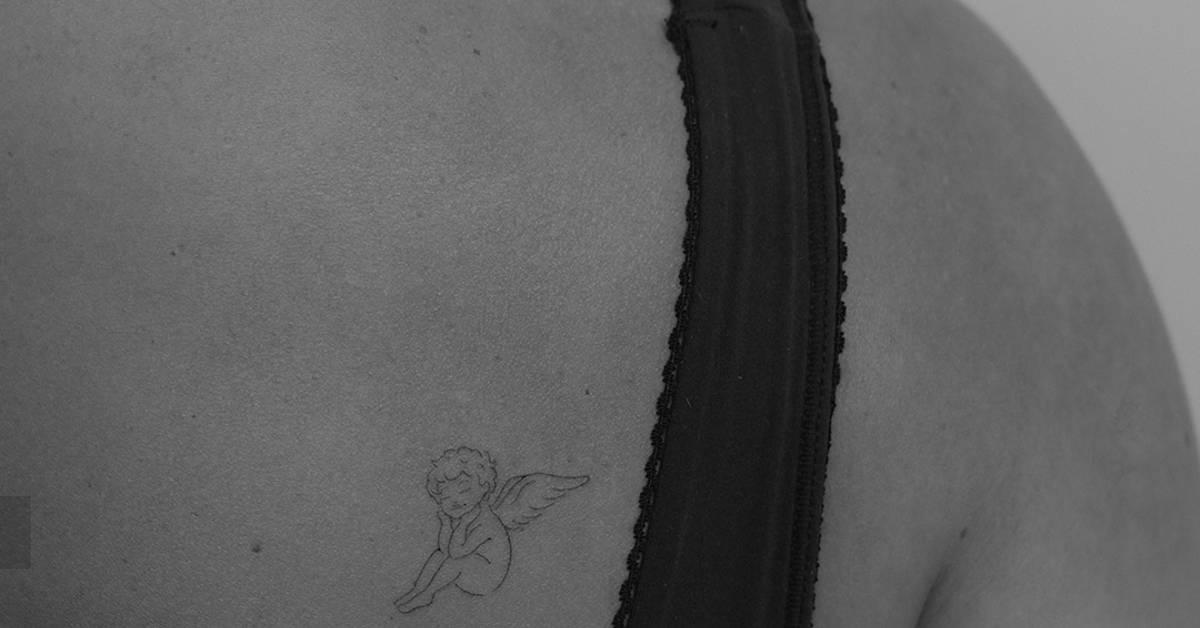 Cherub tattoo in fine line style placed on the shoulder