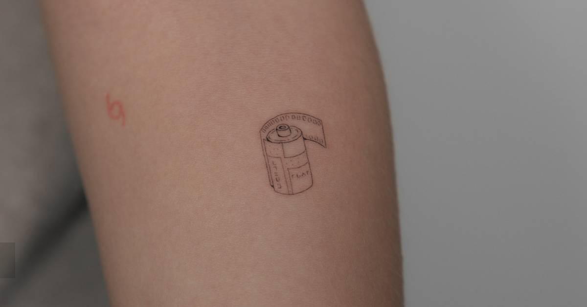 Photographic film tattoo in fine line style located on