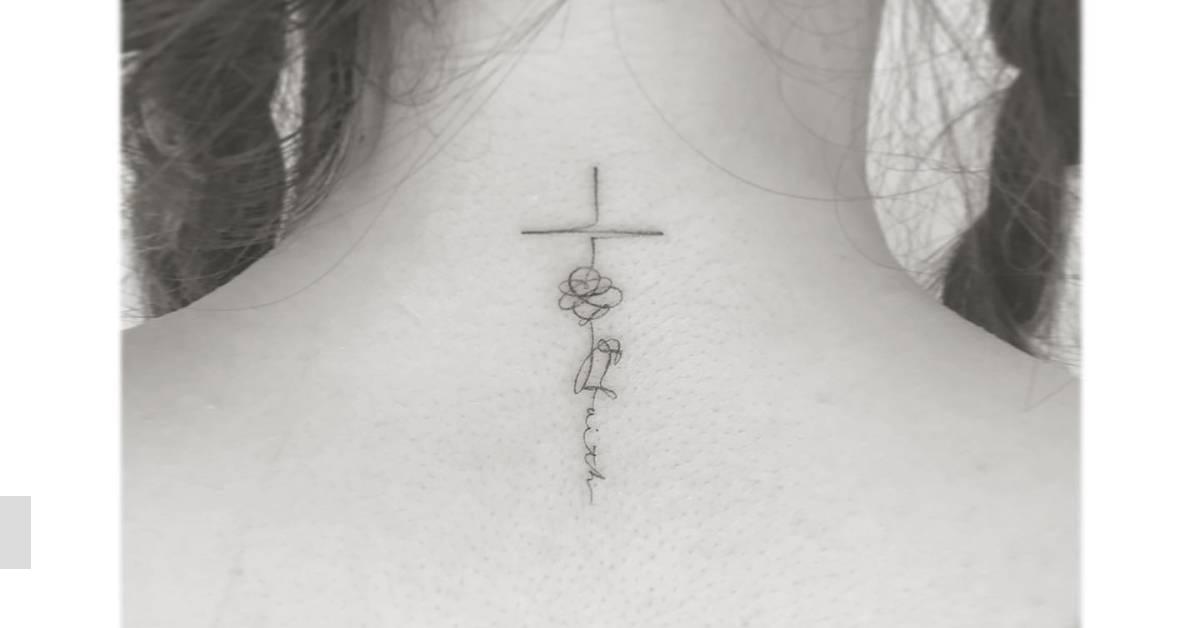One line faith cross tattoo located on the upper back.