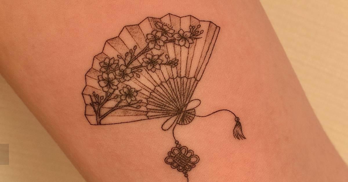 Cherry blossom hand fan tattoo located on the inner