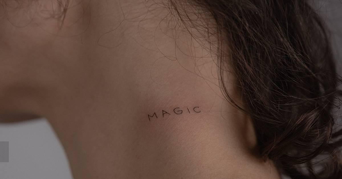 Handwritten lettering tattoo of the word "magic" placed