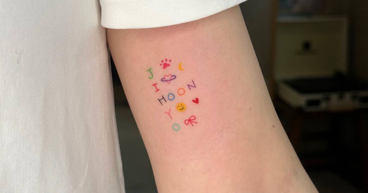 Names and symbols tattoo located on the inner arm.