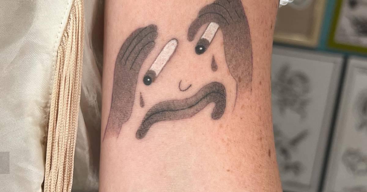 Abstract portrait tattoo located on the bicep.