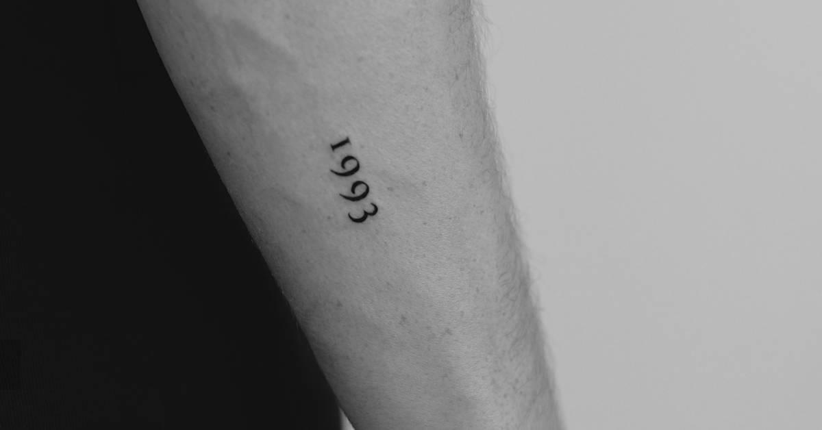 Birth year "1993" lettering tattoo placed on the