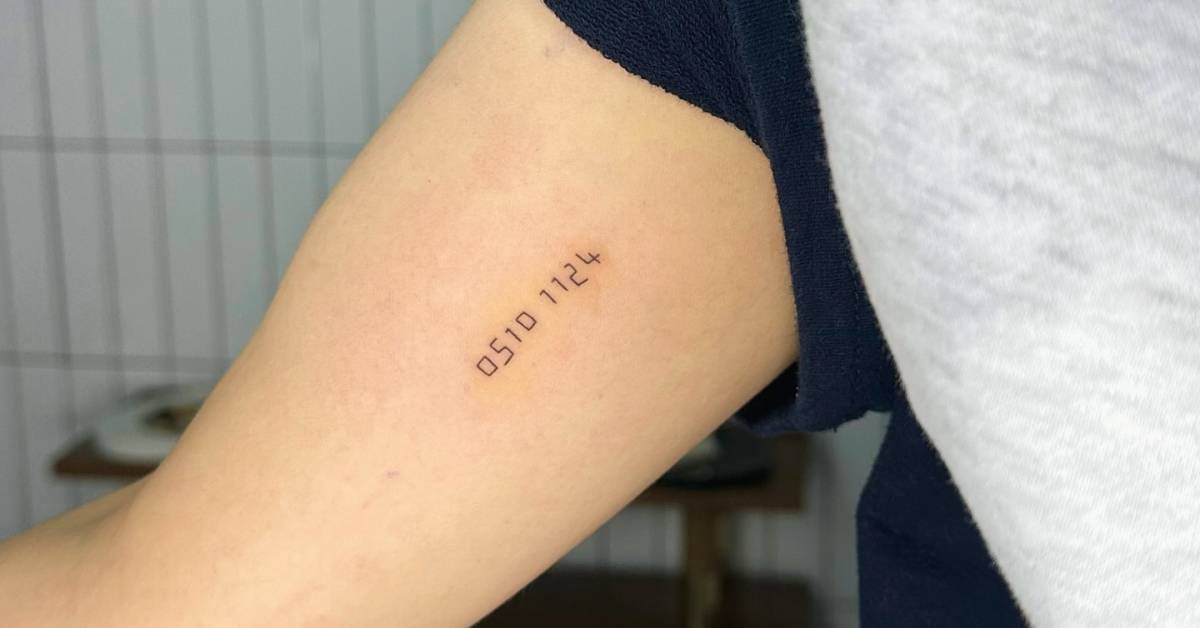 Dates tattoo located on the inner arm, hand poked