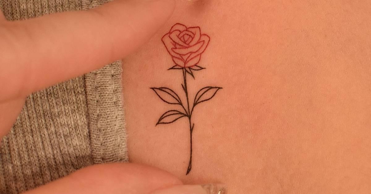 Fine line style red rose tattoo located on the
