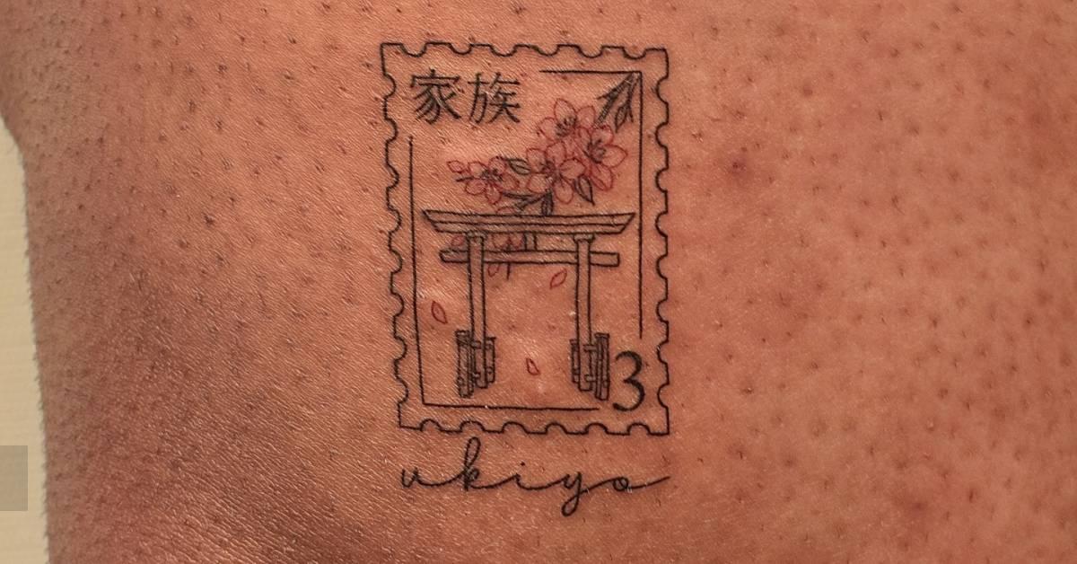 Shinto shrine stamp tattoo located on the thigh, fine