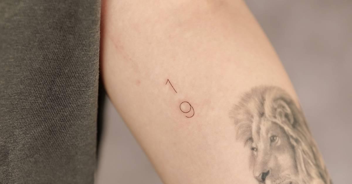 Little tattoo of the number "19" located on the inner
