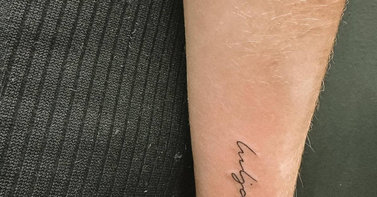 "Lulja" handwritten lettering tattoo placed on the