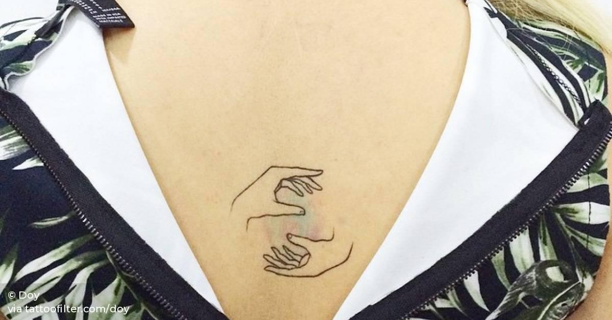 Hand tattoo on the upper back.