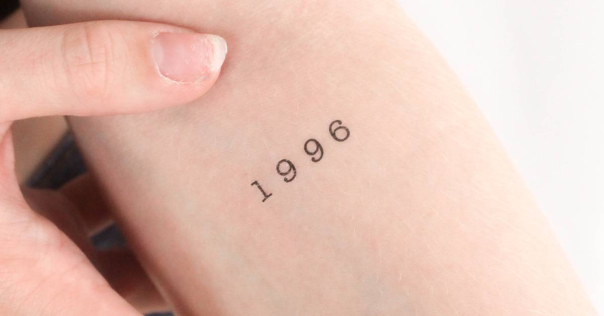 "1996" temporary lettering tattoo located on the inner