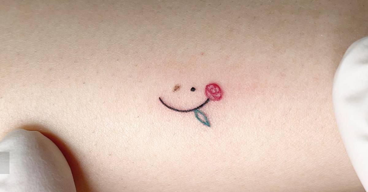 Smiley face an flower birthmark cover up tattoo located