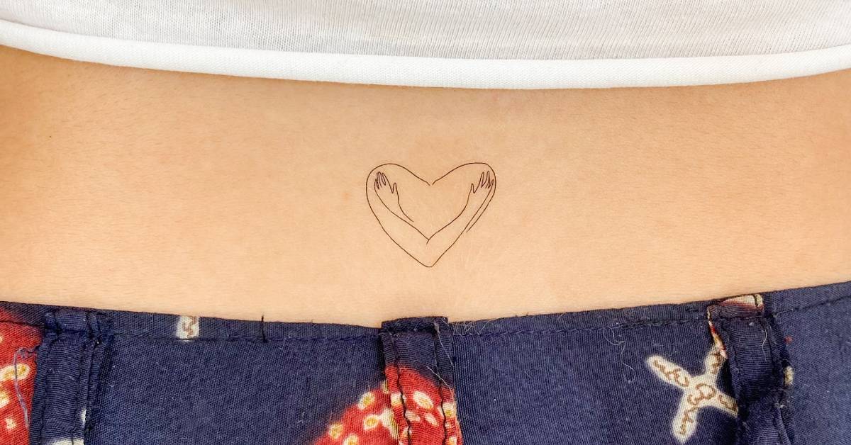Fine line style self hug temporary tattoo placed on the