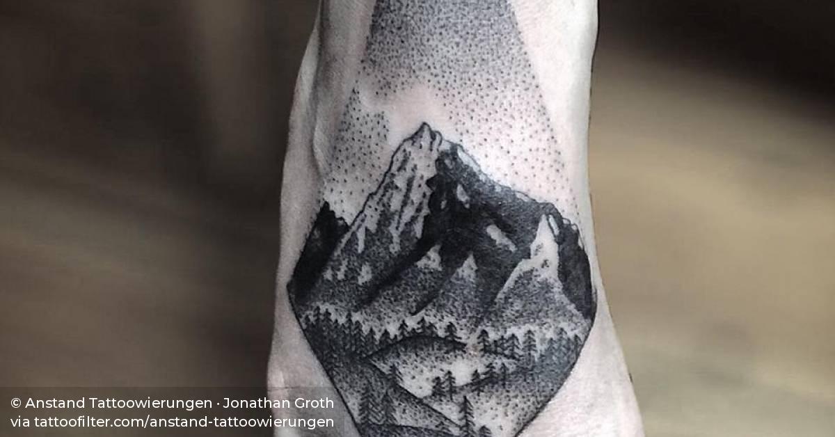 Dotwork style landscape rhombus tattoo on the right