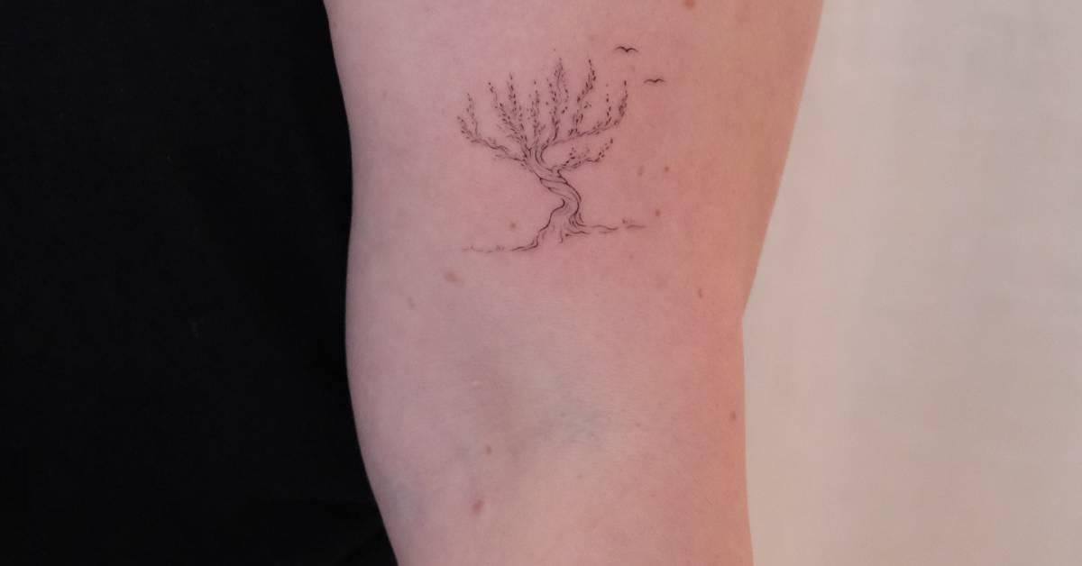 Tree tattoo in fine line style located on the upper