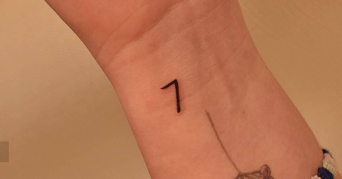 Little tattoo of the number "7" located on the wrist.