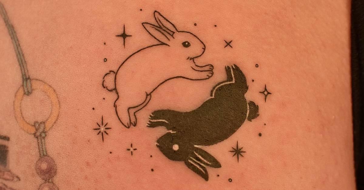 Yin Yang rabbits tattoo located on the upper arm,