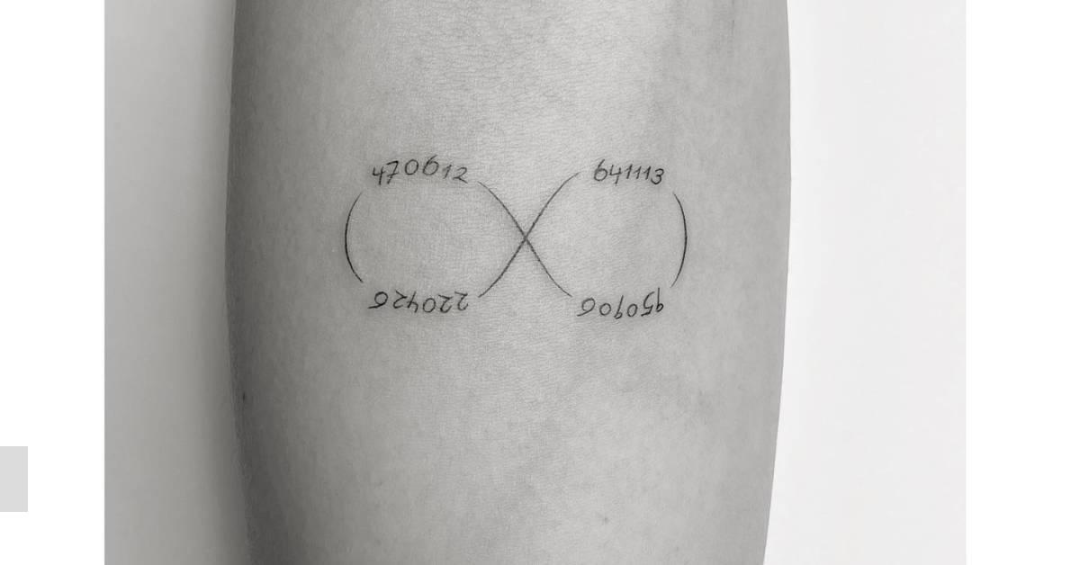 Infinity symbol and dates tattoo located on the inner