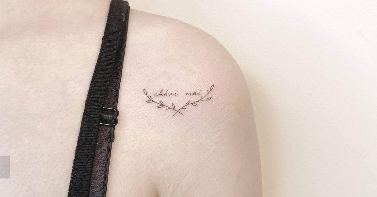 Laurel wreath and "cheri moi" lettering tattoo placed