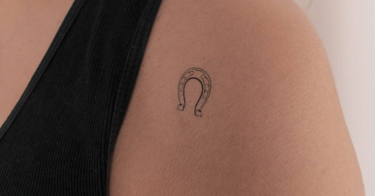 Fine line style horseshoe temporary tattoo located on