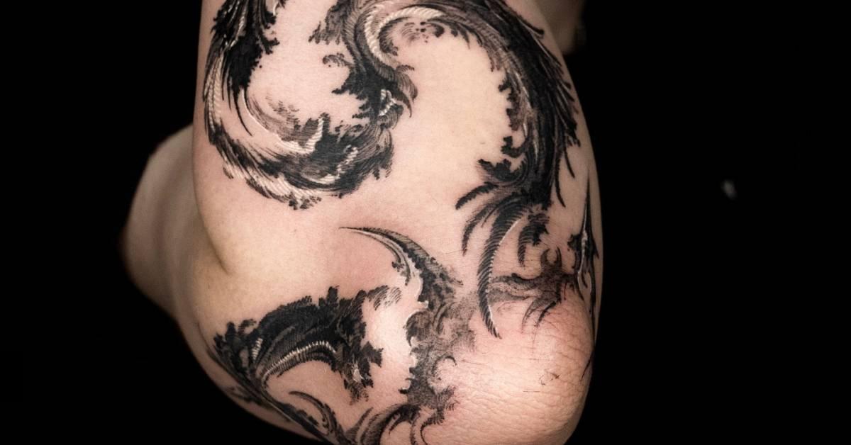 Snake tattoo located on the elbow, watercolor style.