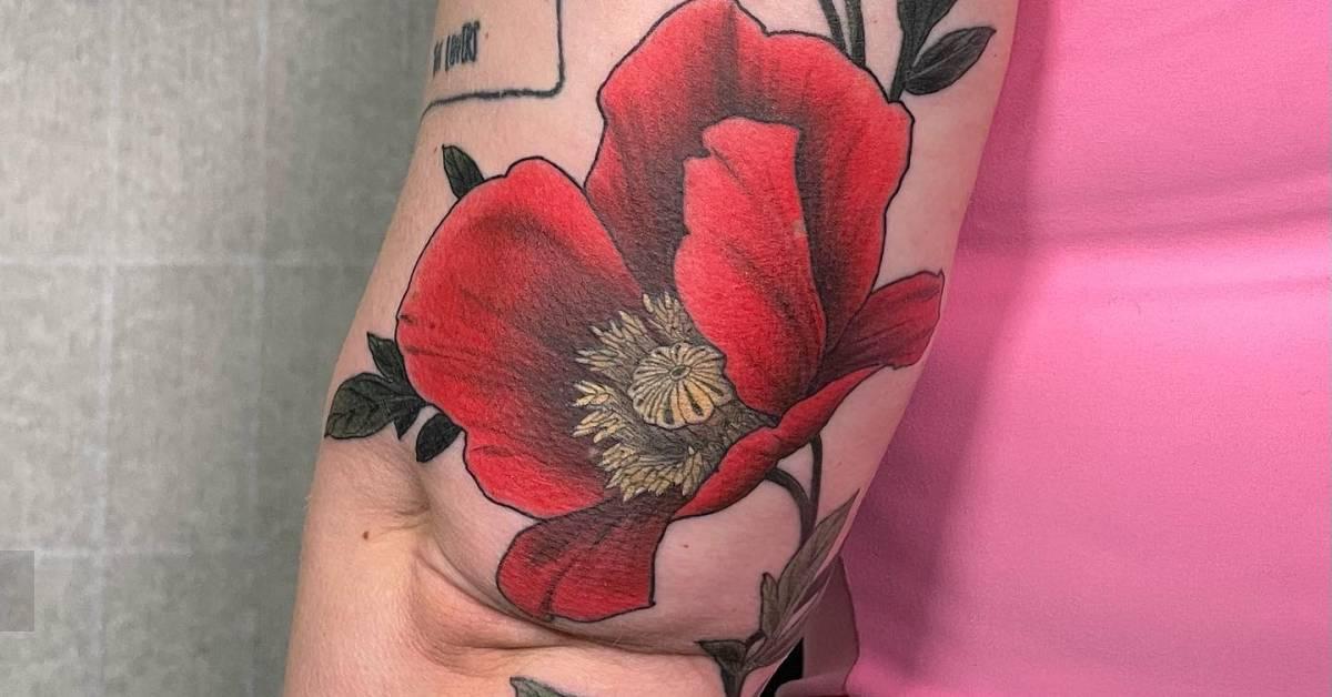 Neotraditional style red poppies tattoo located on the