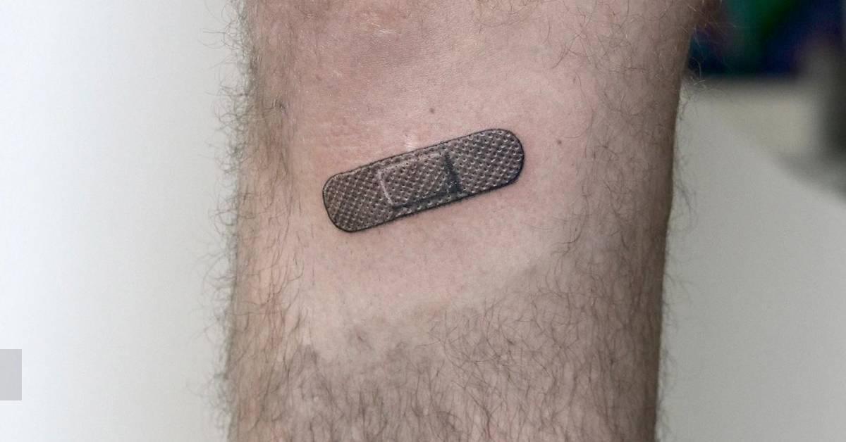 Black and grey style plaster tattoo located on the