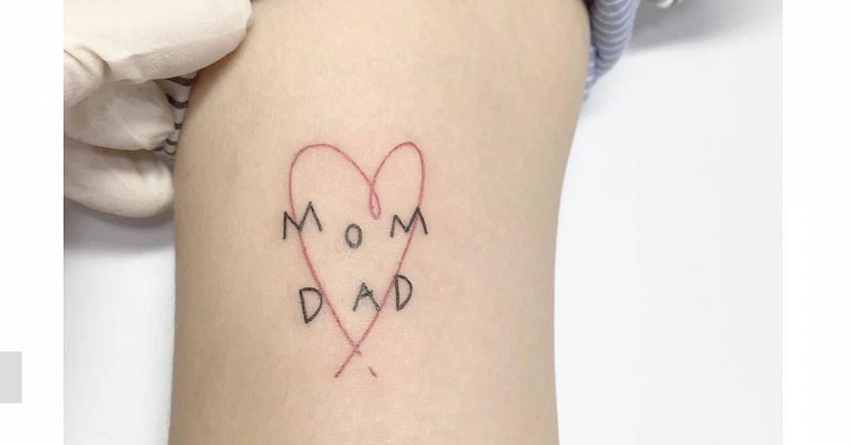"Mom" and "Dad" heart and banner tattoo in minimalistic
