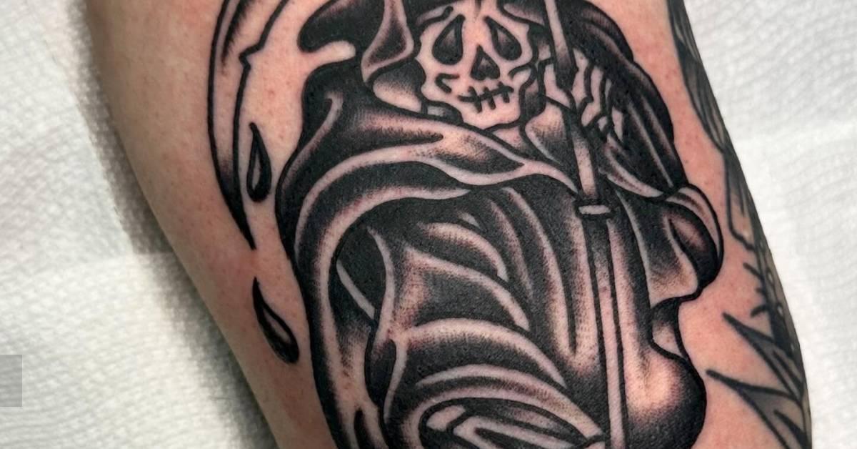 Traditional style grim reaper tattoo located on the