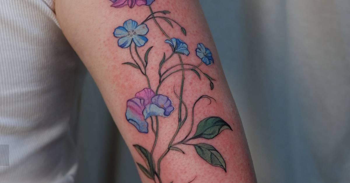Perennial flax and sweet peas tattooed on the tricep.