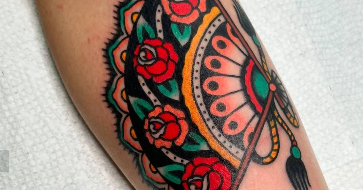 Traditional style hand fan tattoo located on the inner